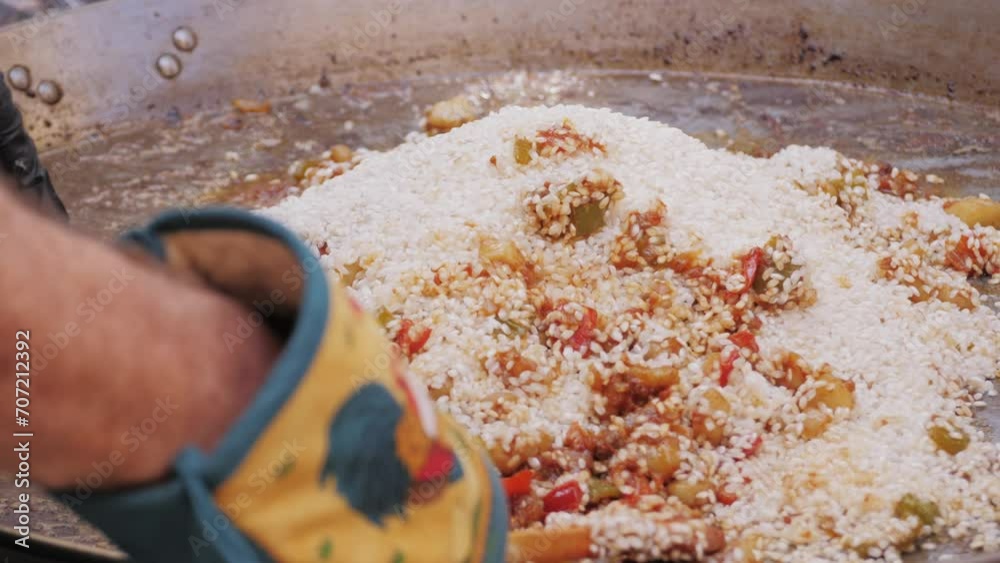 Chef Cooking traditional Spanish Paella on a stove, food festival in ...
