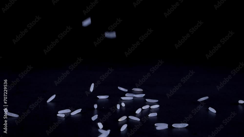Vidéo Stock Basmati white rice falling in slow motion on black ...