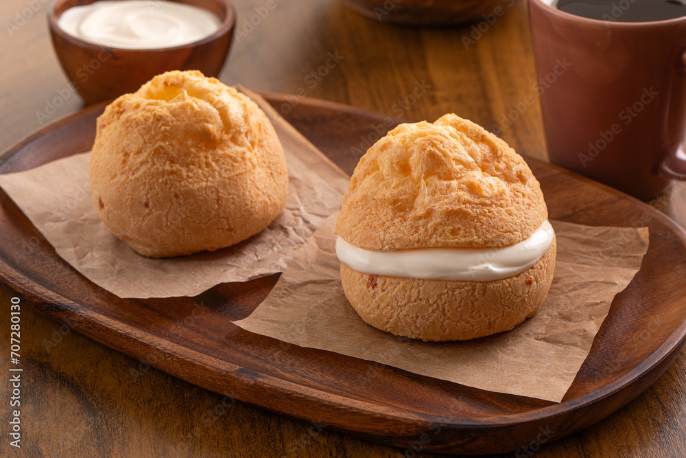 Brazilian snack. Pão de Queijo filled with requeijão (Brazilian creem ...
