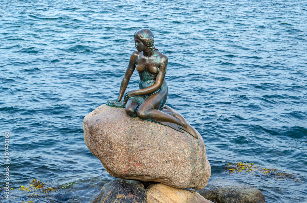 COPENHAGEN, DENMARK - JULY 8, 2014: The Little Mermaid, bronze statue by Edvard Eriksen ...