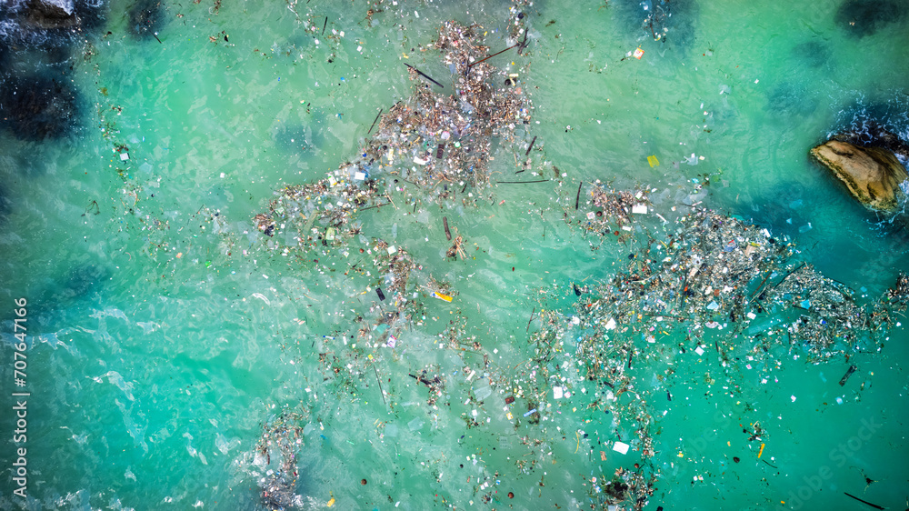 Aerial view of plastic pollution and debris floating in vibrant ...