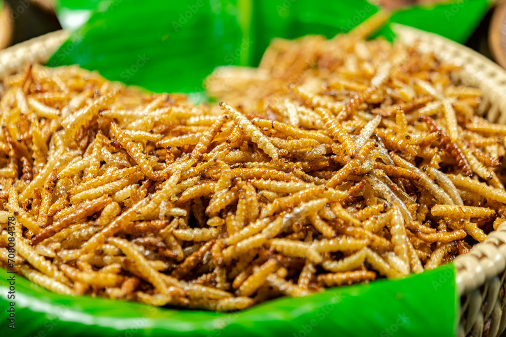 Thai street food, deep fried silk worms selling in the market or along ...