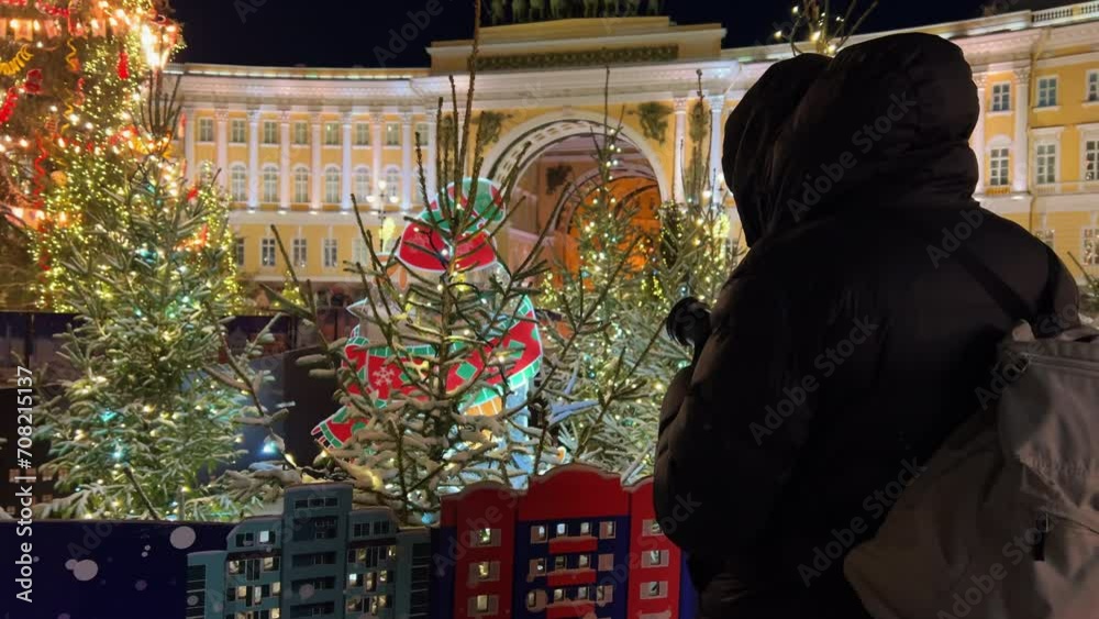 Anonymous man shooting beautiful Christmas fare outdoors. Camera man ...