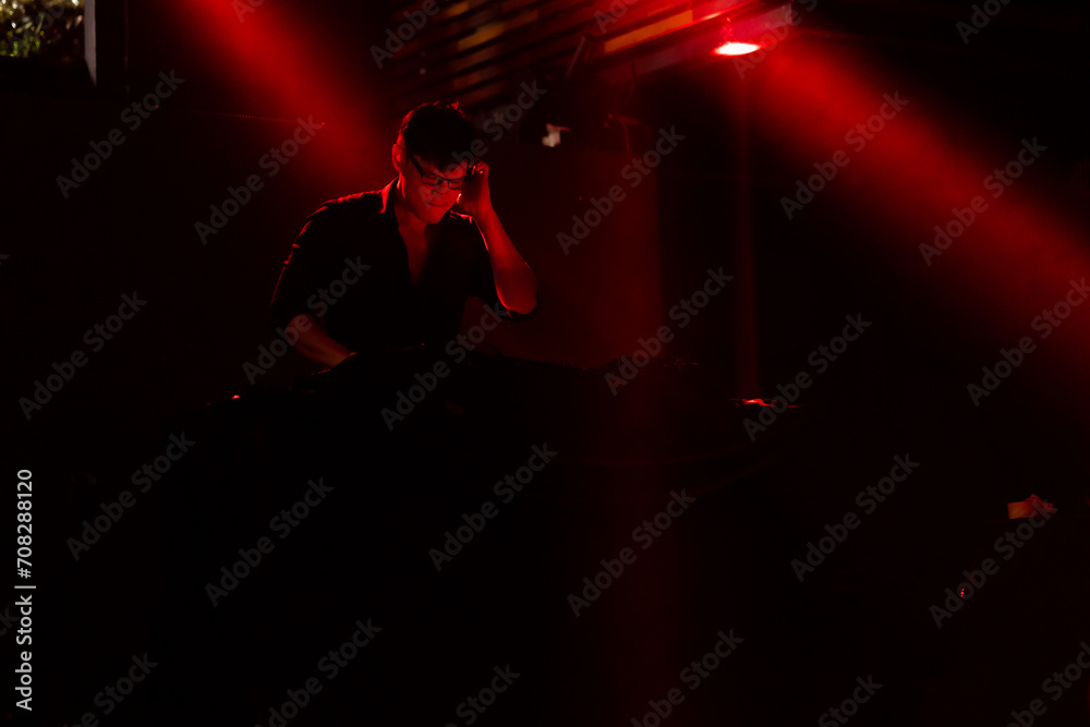 DJ with Turntables at nightclub. Group of diverse young people dancing ...