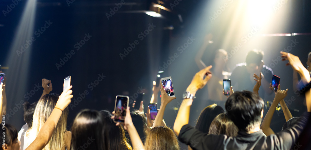 DJ with Turntables at nightclub. Group of diverse young people dancing ...