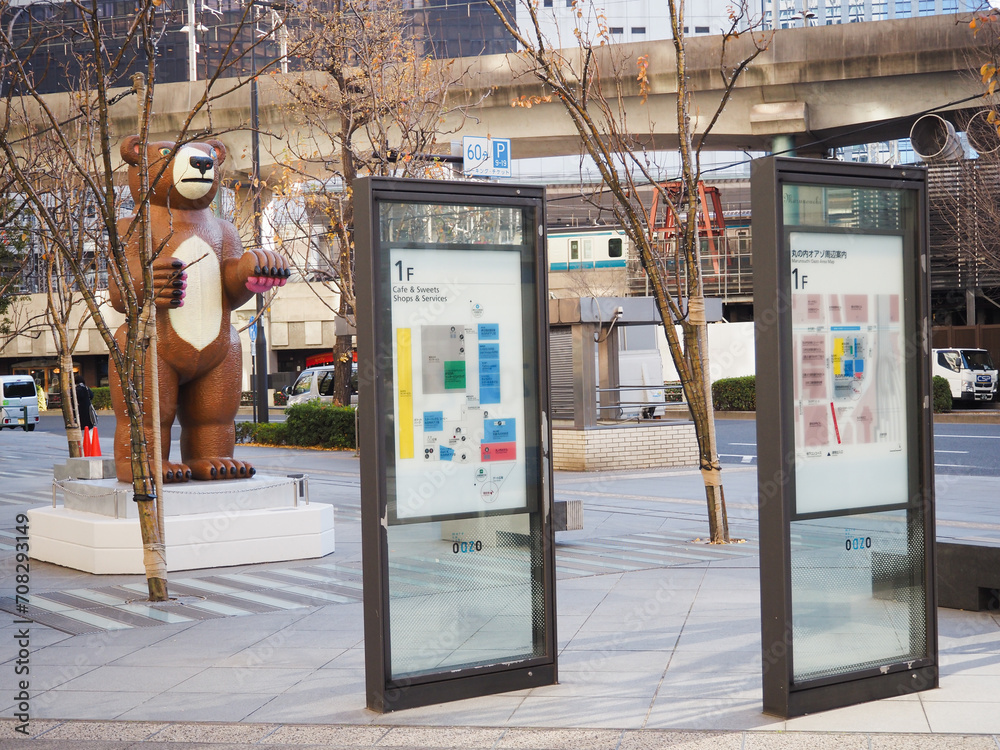 TOKYO, JAPAN - January 12, 2024: Maps and a statue of a bear outside ...