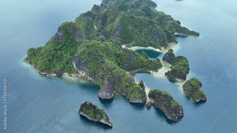 Craggy limestone islands, fringed by coral reefs, rise from the amazing ...