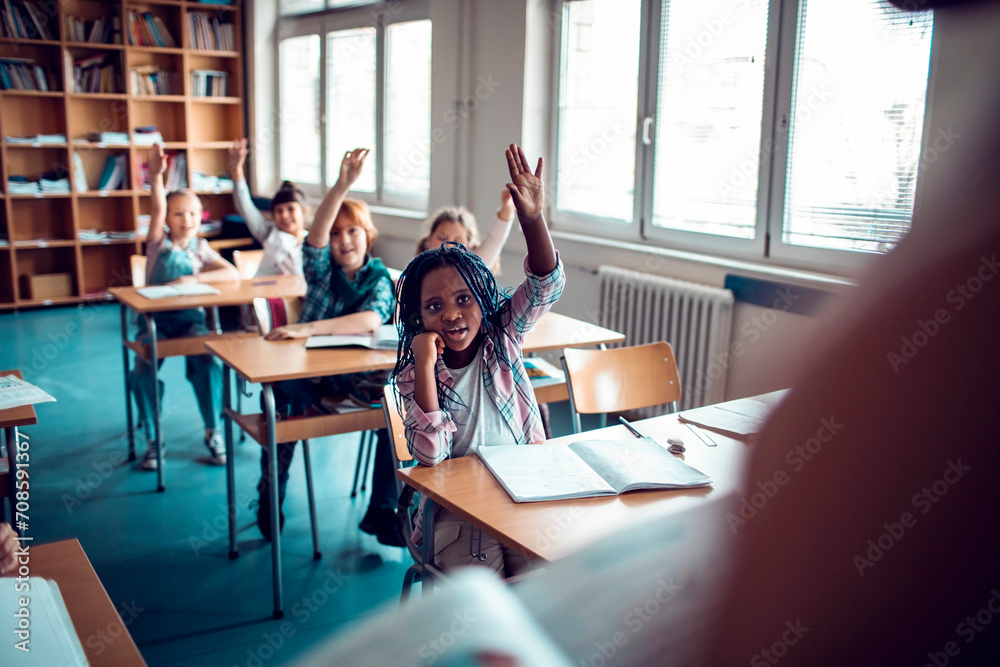 Children raising hands in elementary school classroom Stock Photo ...
