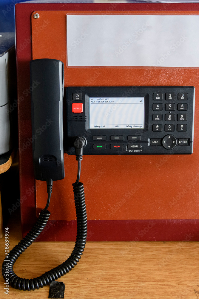 Navigational control panel and VHF radio with hand. Radio communication ...