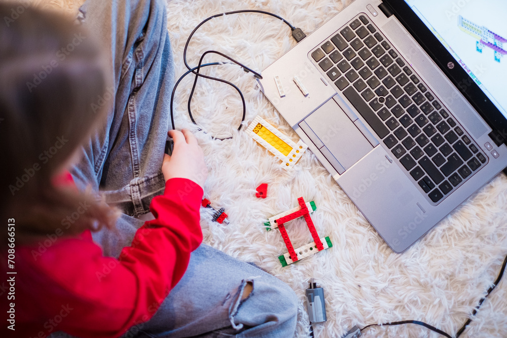 Tallinn, Estonia - December 25, 2023: Child building a moving Lego ...