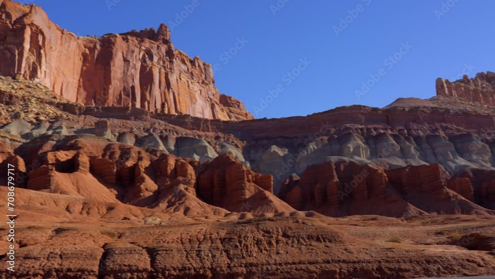 Establishing shot of mountains with red rocks background in The Castle ...