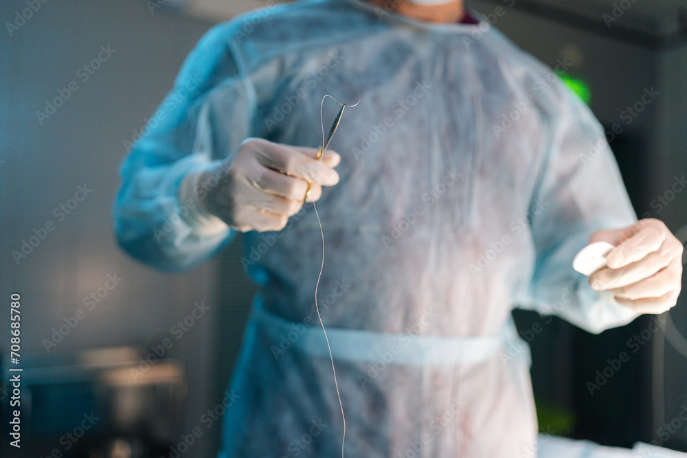 Closeup hands of unrecognizable professional surgeon wearing uniform ...
