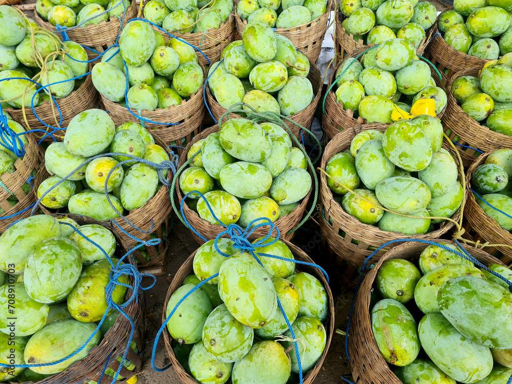 tropical fruit market. Indonesian local market. Stacks of mangoes in ...