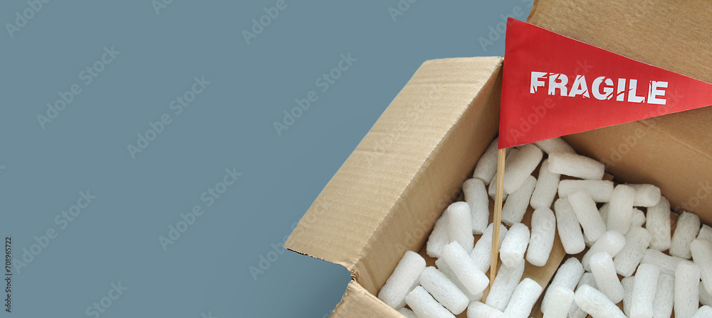 Opened cardboard packaging box with white polystyrene packing chips ...