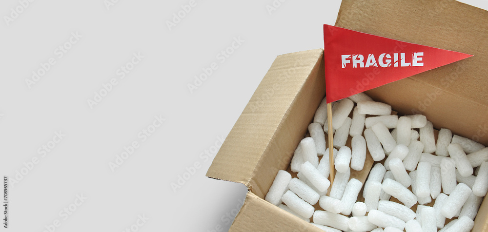 Opened cardboard packaging box with white polystyrene packing chips ...