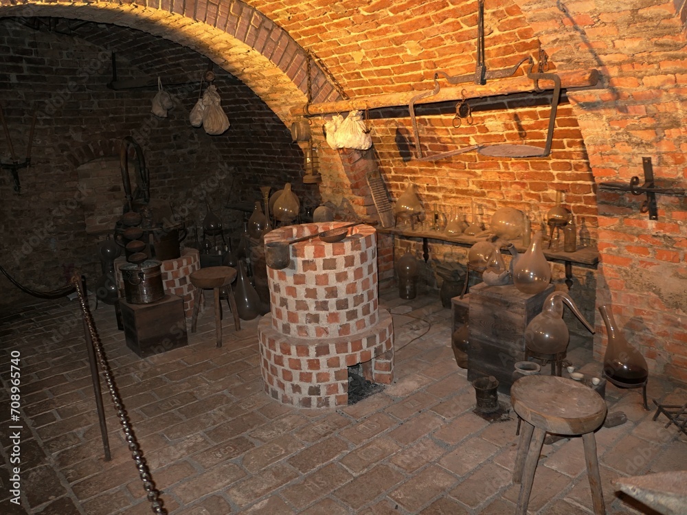 Medieval alchemist laboratory with various retorts, anvil and furnace ...