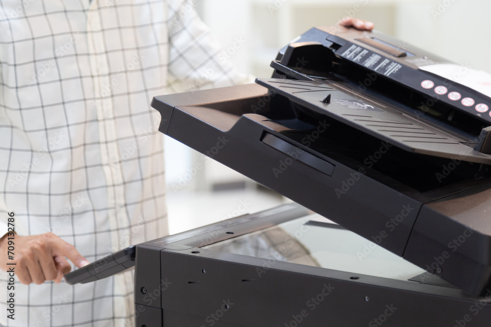 Bussinessman press button on panel of printer photocopier network ...