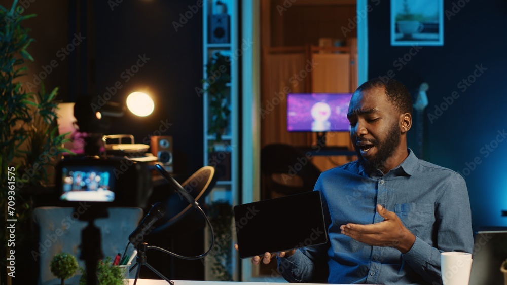 Technology content creator filming review of newly released tablet ...