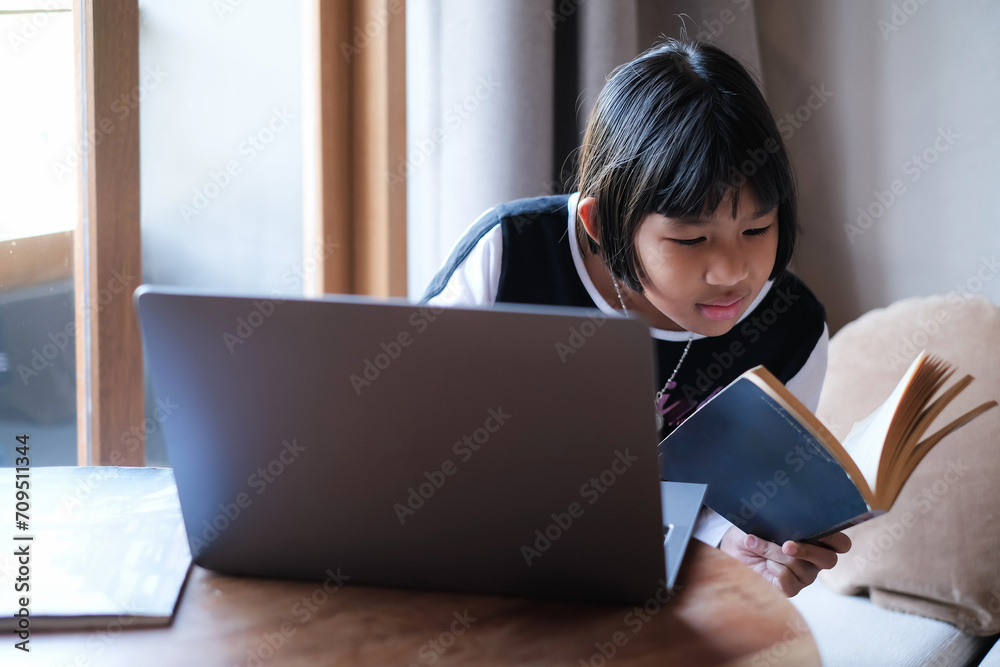 Cute and happy little girl child using laptop computer making facetime ...