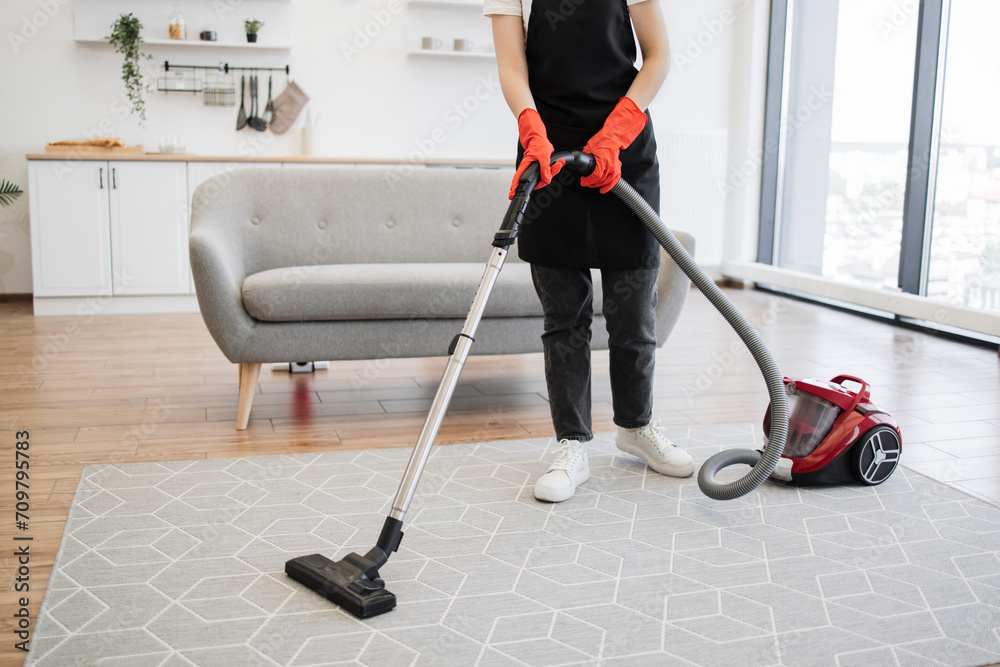 Cropped view of hands holding vacuum cleaner of Caucasian female ...