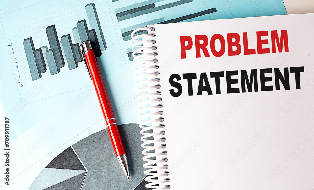 PROBLEM STATEMENT text on a notebook with pen on a chart background ...