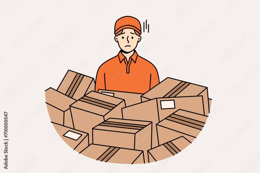 Sad man courier stands among scattered cardboard boxes, suffering from ...