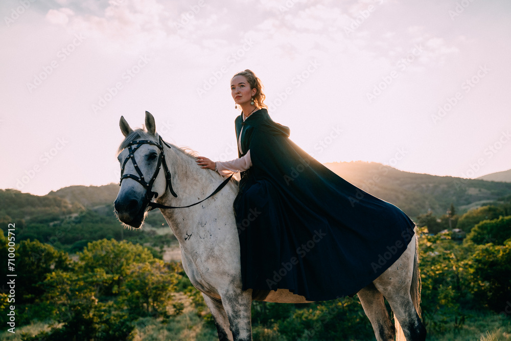 Fantasy story, a young charming girl sitting on a white horse, a fairy ...