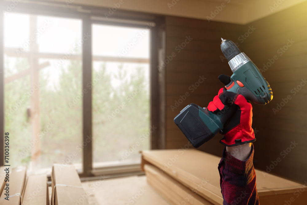 Driller. Man brings a electric drill to the camera. Worker wants to ...