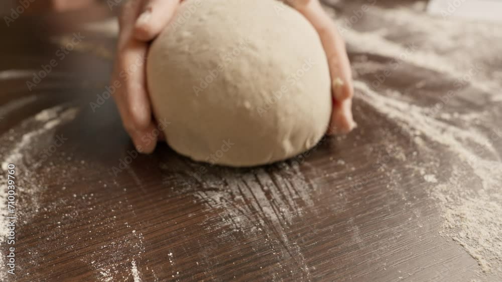 Bakery worker carefully forming loaf of bread. Male hands kneading ...