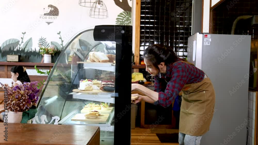 Asian barista waitress worker female selling bakery in cafe coffee shop ...