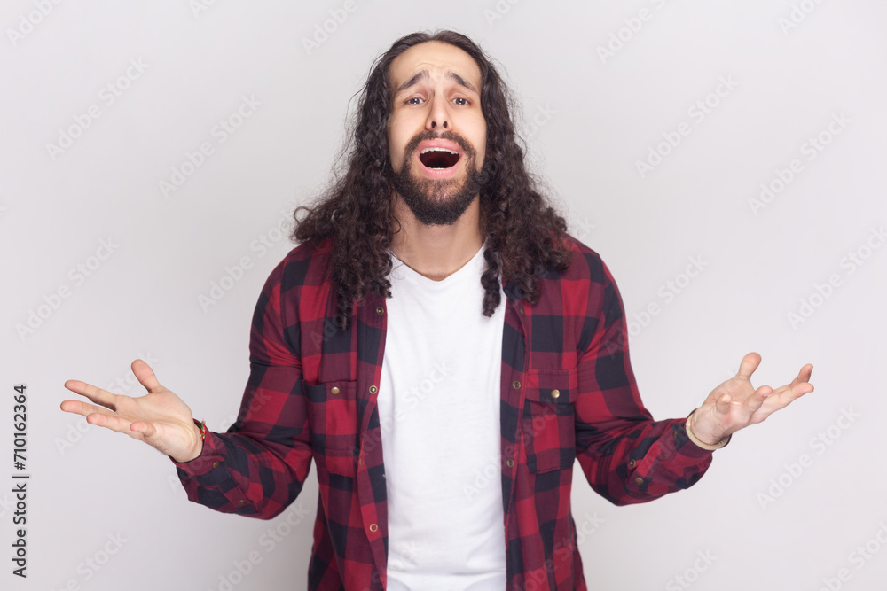 Portrait of Aggressive outraged bearded man with long curly hair in ...