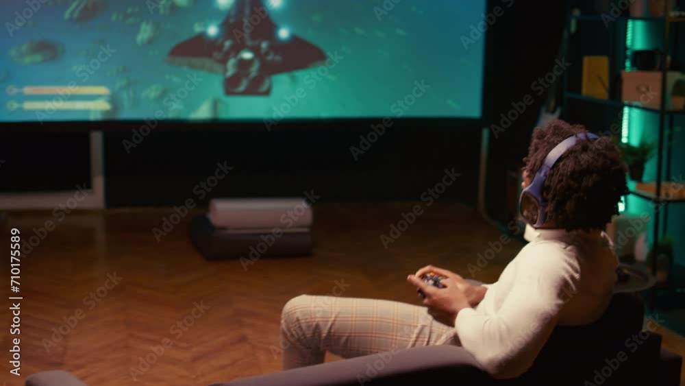 African american gamer plays game with spaceship shooting laser streams ...