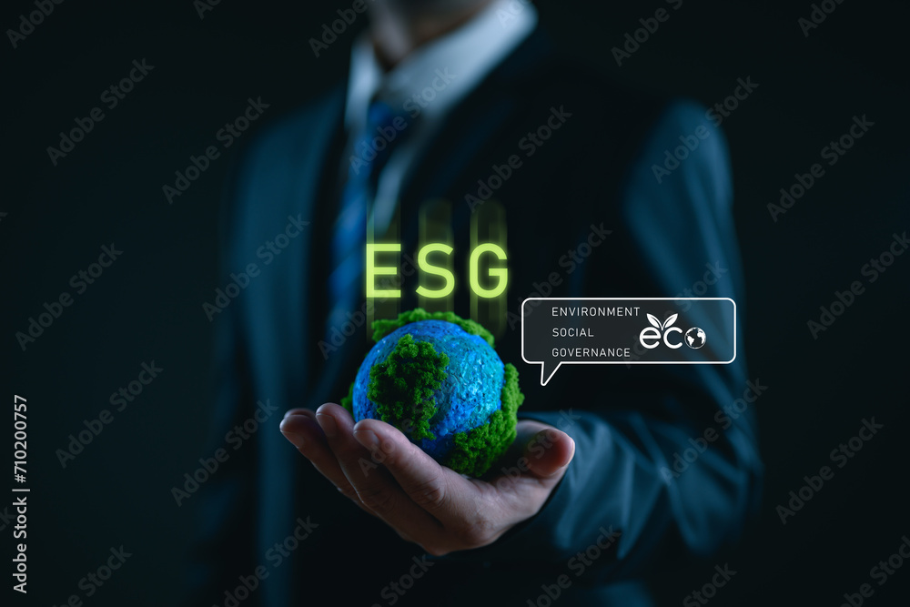 Businessman holding globe with ESG icon green earth concept for ...