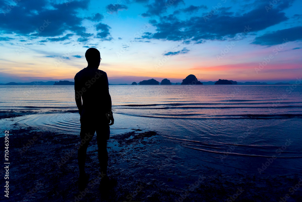 Lonely Asian middle edge man standing on the beach watching sunset sky ...