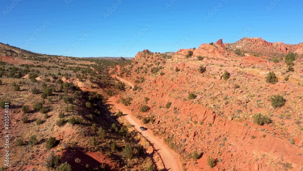 Suv vehicle driving on curved dusty ground rural road that crosses ...