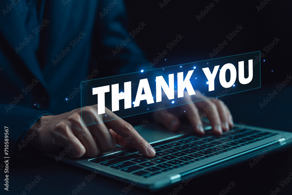 businessman using a laptop and showing the message thank you on a ...