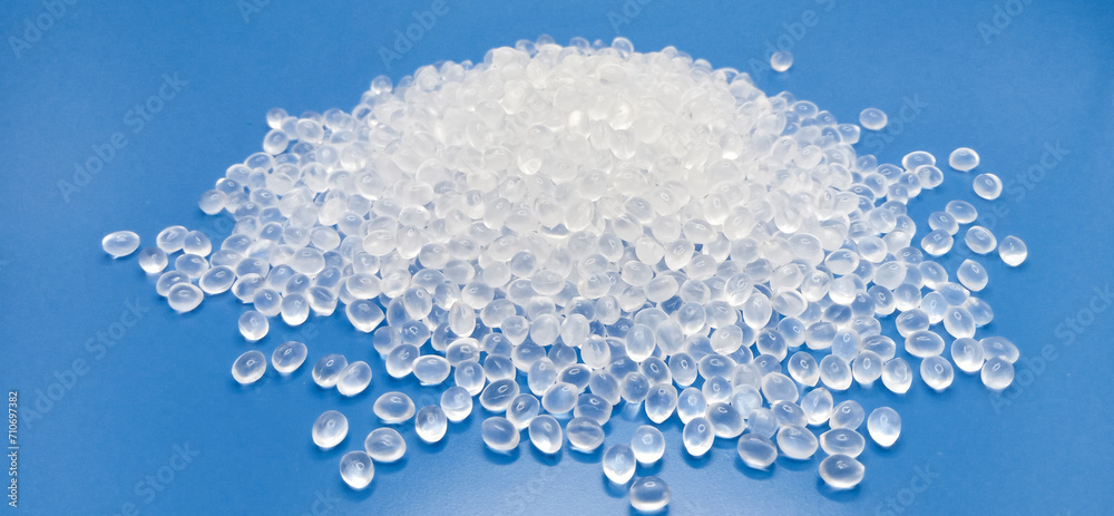 virgin polymer material granules isolated on a blue background for ...