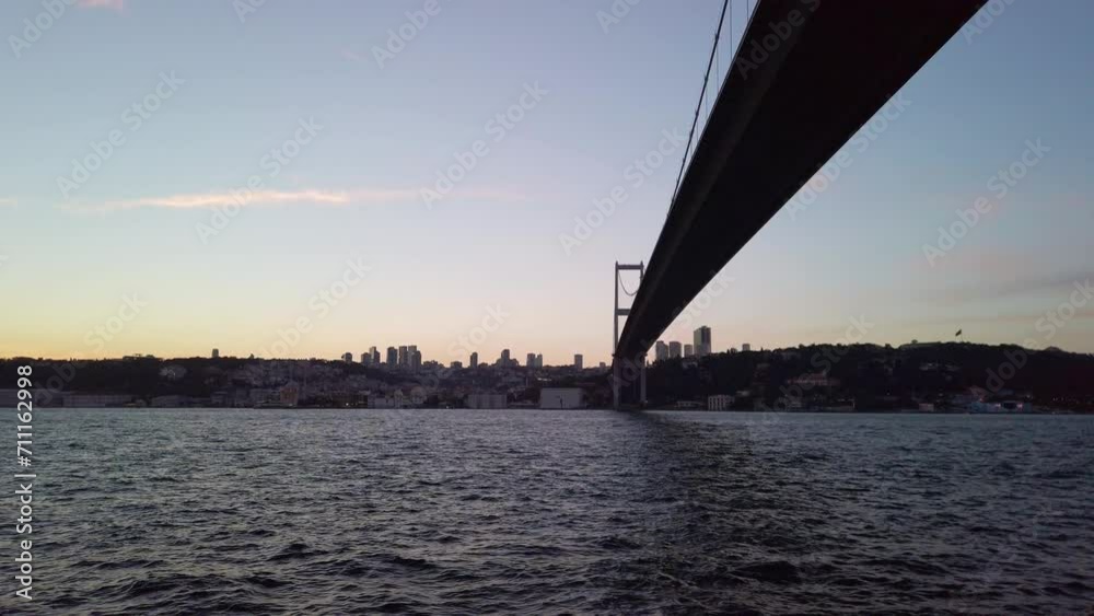 Evening, slow-mo, silhouette of Fatih Sultan Mehmet Bridge (from below ...