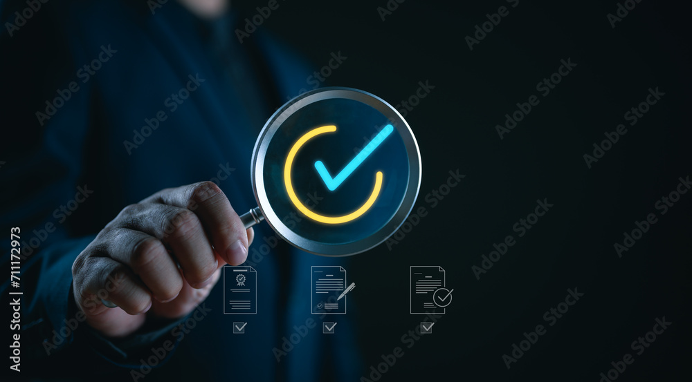 Businessman hand holding magnifier glass for quality control concept ...