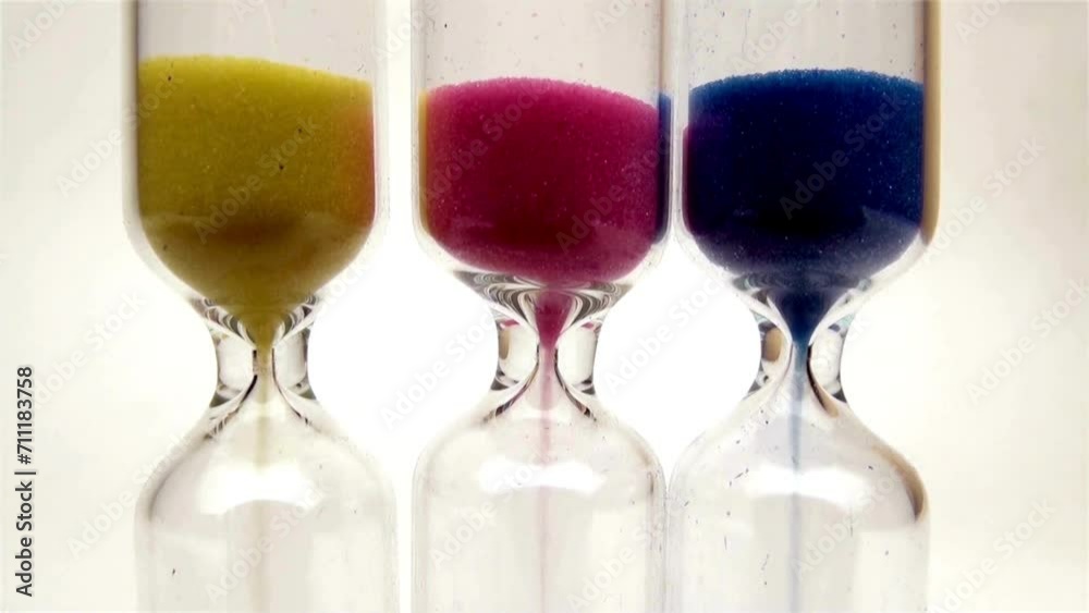 A shot of sands falling through a sand timer. Sand-glass isolated on ...