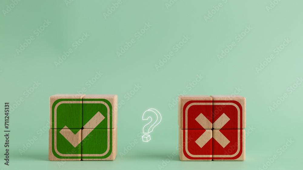 Tick mark and cross mark on a wooden cube. the decision between Yes or ...