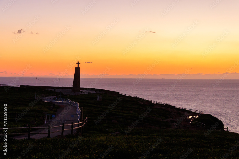 Cabo da Roca cross monument at sunset. Cabo da Roca or Cape Roca is ...