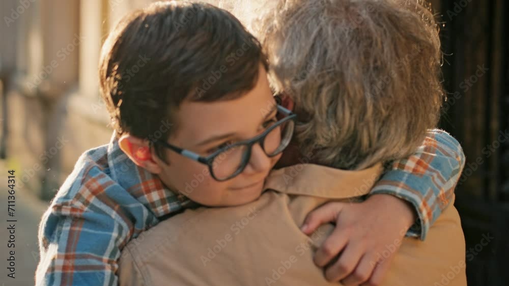 Older Caucasian father or grandfather hugging little boy in middle of ...