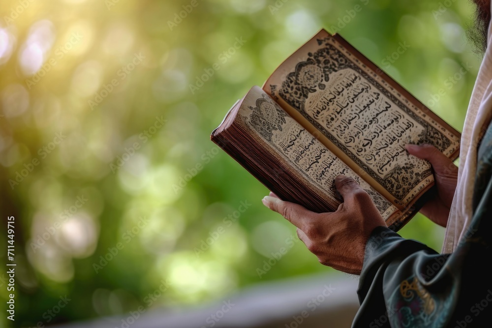 Man Holding and reading quran. Islamic Background. Arabic on the text ...