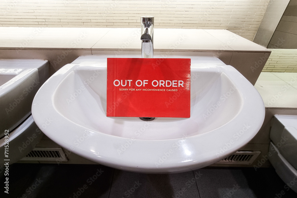 Elegant and modern wash basin with Out of Order signage placed below ...
