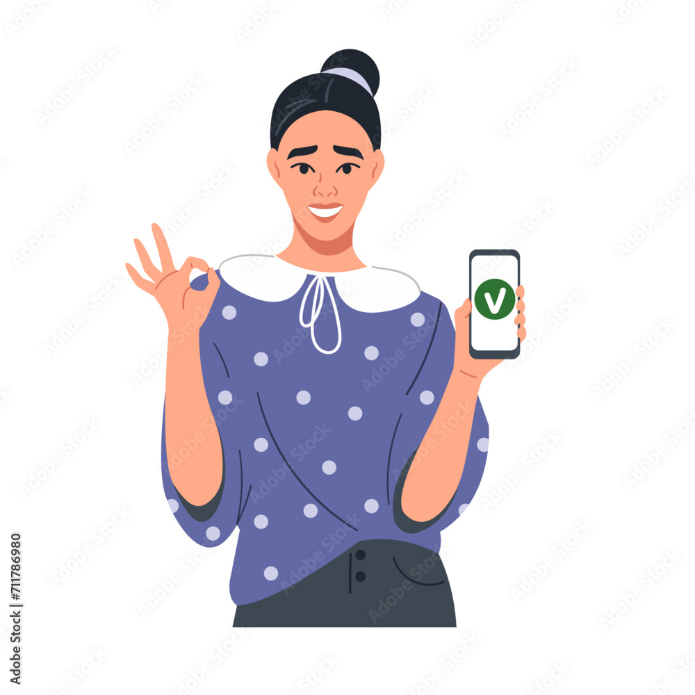 A happy young woman shows the screen of her smartphone in one hand and ...