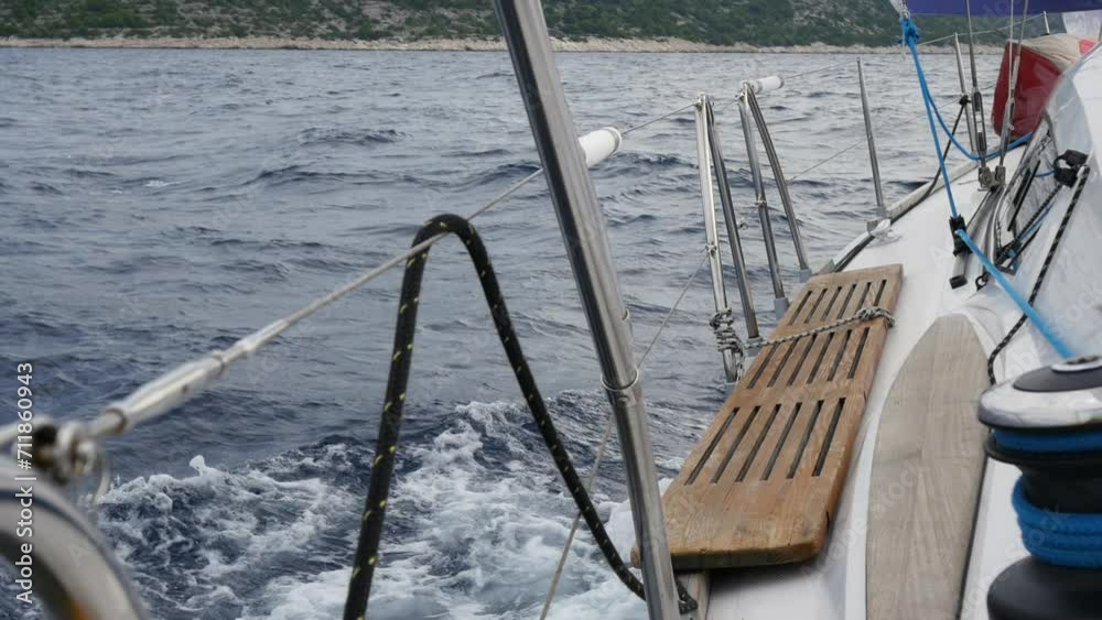 Side and details of yacht deck on background of water surface. Ropes ...