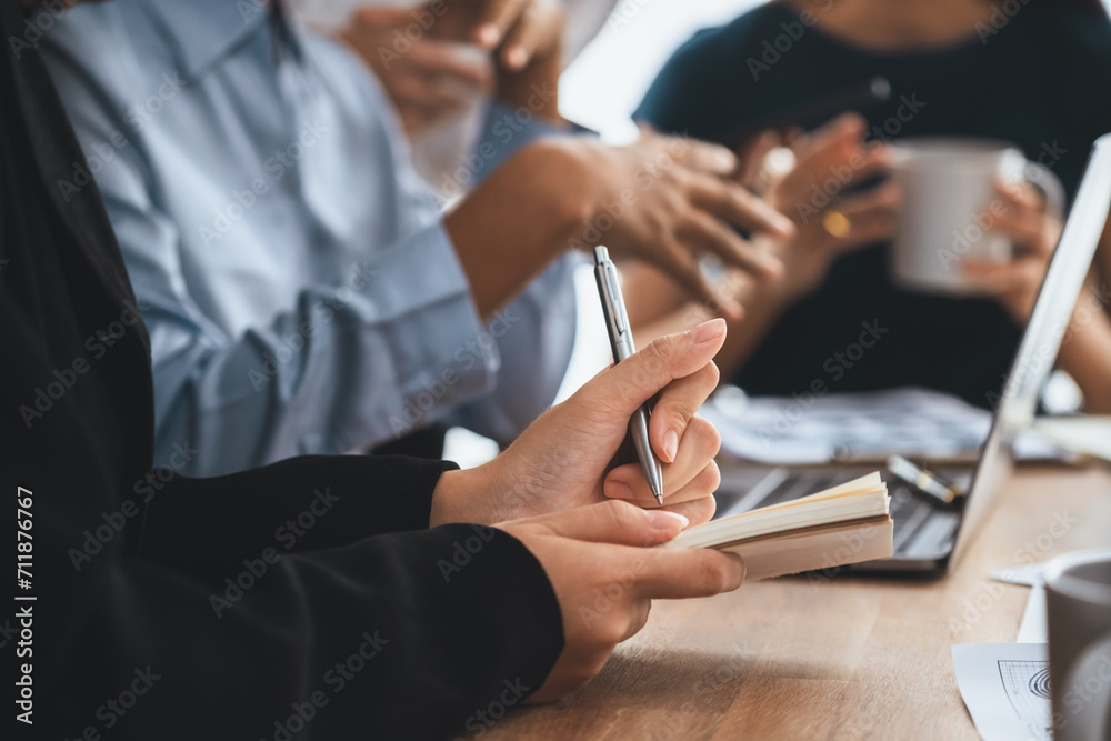 Secretary taking notes on notebook at corporate meeting with group of ...