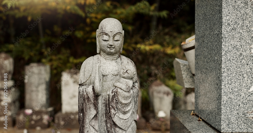 Buddha, statue in Japan graveyard with child for safety, protection and ...
