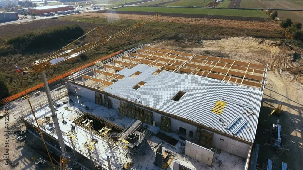 Warehouse construction process drone aerial view 4K. Top view jib shot ...